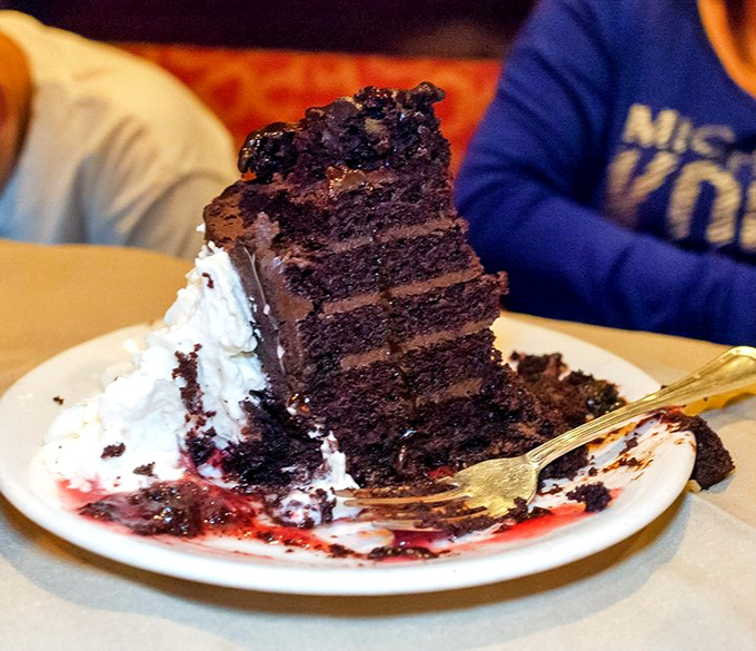 This towering chocolate cake isn't just dessert &ndash; it's an architectural achievement of cocoa engineering that demands to be photographed before demolished.