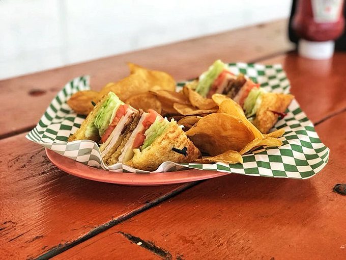 A club sandwich built like a skyscraper of flavor&mdash;the architectural marvel of lunch options that requires strategic first bites.