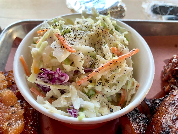Coleslaw that knows its role &ndash; not just a side dish but a crucial counterpoint to the smoky richness, like a palate-cleansing best friend.