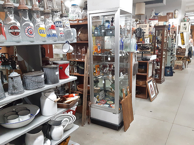 Cast iron cookware and vintage kitchen tools stand ready for their second act. These seasoned veterans have stories simmered into their surfaces.