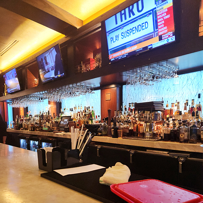 The bar isn't just well-stocked; it's a liquid library with enough options to write a dissertation on fine spirits.