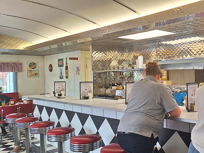 The counter &ndash; where solo diners find community, watching short-order ballet performed behind a diamond-patterned stage of black and white.