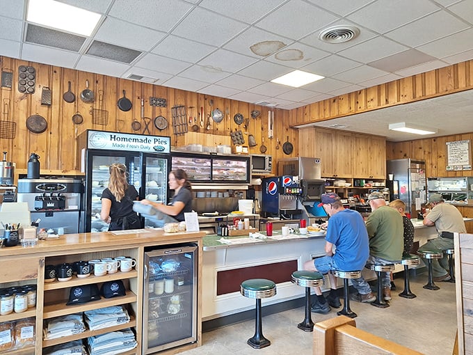The counter – where regulars become family and first-timers become regulars. Notice the pie case standing guard like a dessert sentinel.