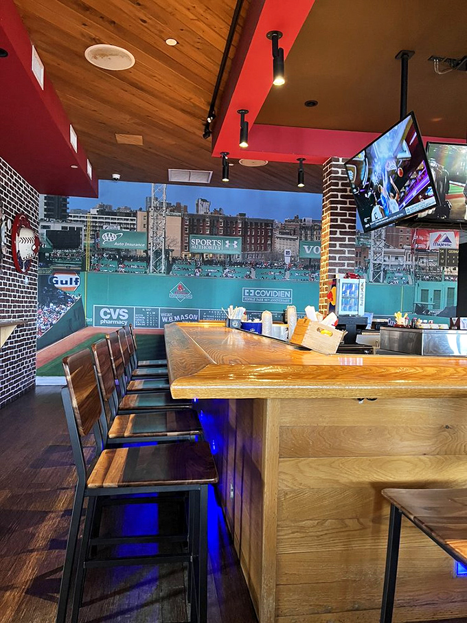 Where Boston meets beach: wooden bar seating facing Fenway's Green Monster mural. Baseball and beachfront&mdash;an unlikely marriage that somehow works perfectly.