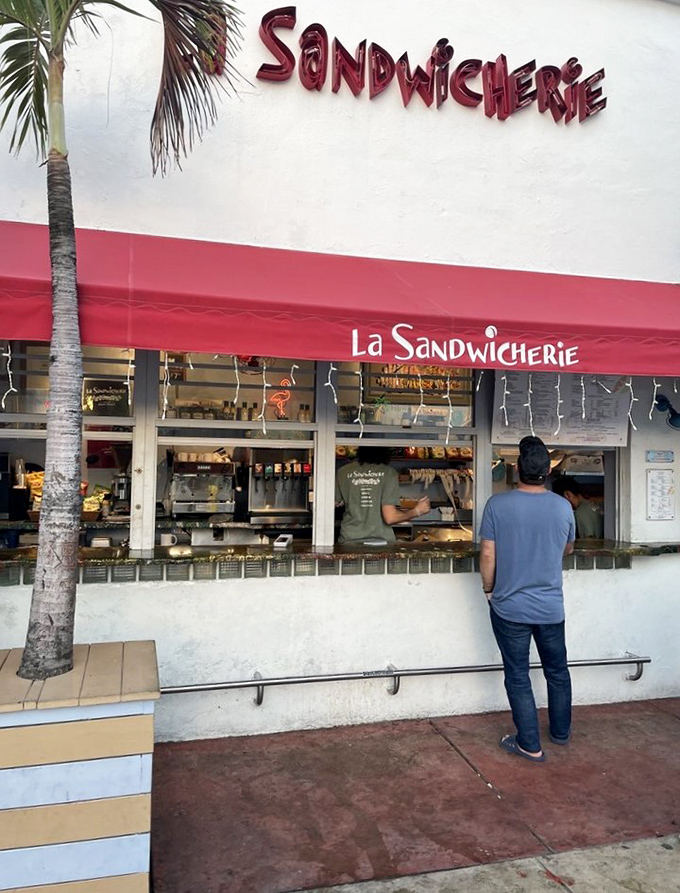 The universal posture of sandwich anticipation. This customer knows good things come to those who wait at La Sandwicherie's counter.