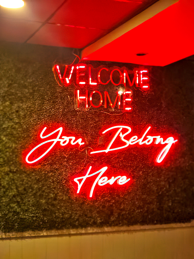 The "Welcome Home" neon isn't just decoration&mdash;it's truth in advertising for a place that feels like a backyard BBQ hosted by your coolest friend.