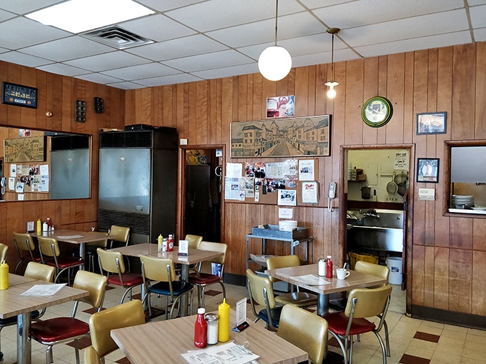Wood paneling, vintage memorabilia, and the soft glow of ceiling lights create the perfect backdrop for serious sandwich business.