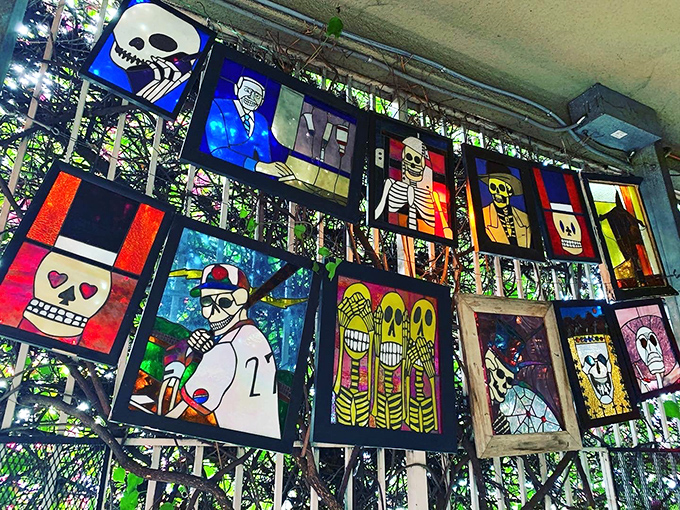 Stained glass gets a morbid makeover with these colorful panels featuring skeletons in various poses. Death becomes surprisingly vibrant in artistic interpretation.