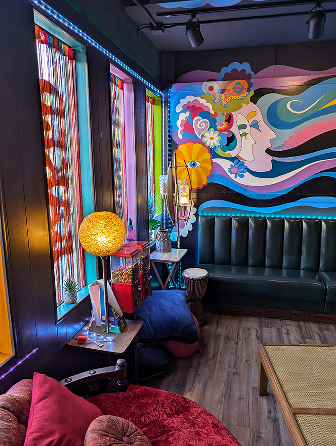 The windows lined with colorful streamers filter light like stained glass, creating an atmosphere that's part cathedral, part Woodstock '69.