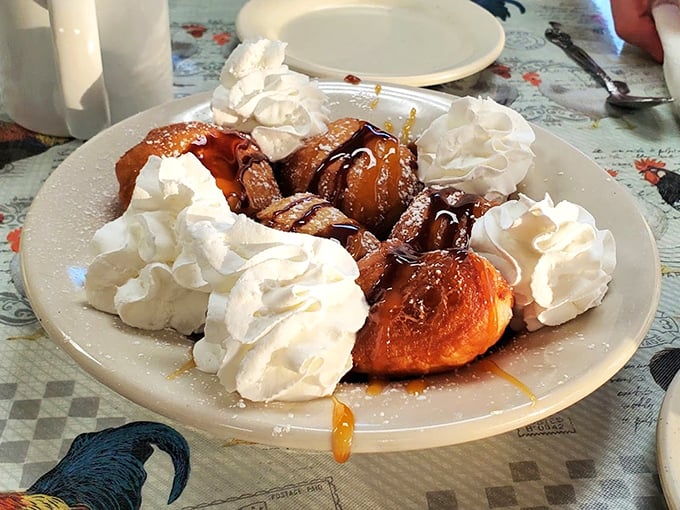 Whipped cream mountains surrounding what appears to be cinnamon-dusted pastry islands in a sea of caramel. Breakfast or dessert? Yes.