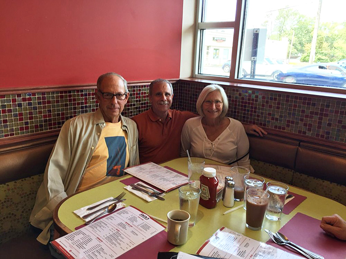 Three generations sharing one table, multiple menus, and the kind of conversation that only happens when everyone's anticipating something delicious.