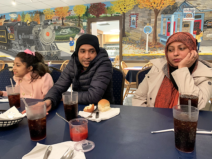 The vibrant wall murals don't just decorate&mdash;they tell stories of the community that surrounds and sustains this beloved eatery. Note the steam engine's nostalgic appeal.