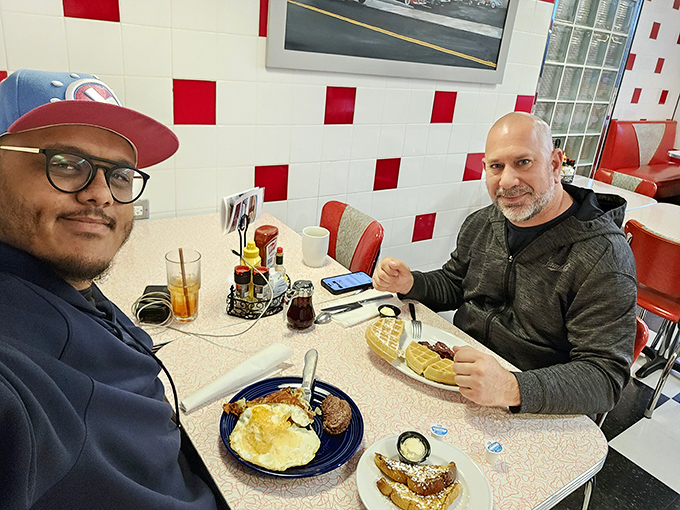 Happy diners enjoying the fruits of Goobers' labor&mdash;plates of golden breakfast classics that inspire conversation and satisfied smiles.