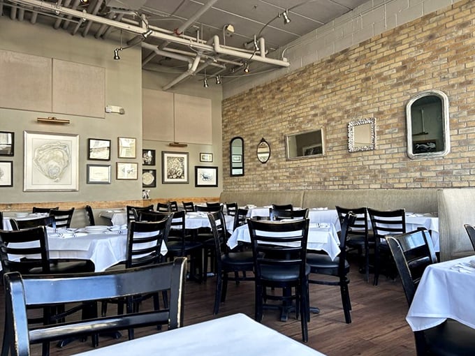 White tablecloths meet exposed brick in a dining room that says "we're serious about food" without being stuffy about it.
