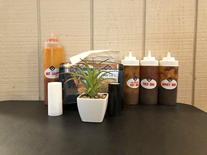 The sauce lineup: where hot, mild, and honey BBQ wait patiently to elevate your meal from delicious to transcendent.