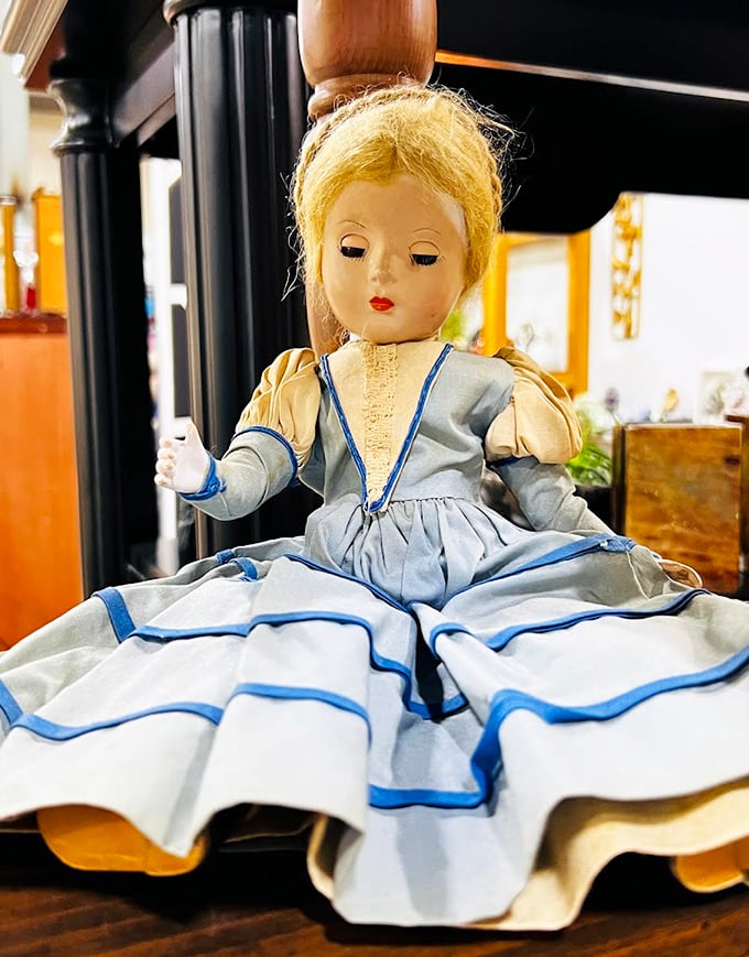 This vintage doll has seen things. Her pristine dress and thousand-yard stare suggest she's keeping secrets from another era.