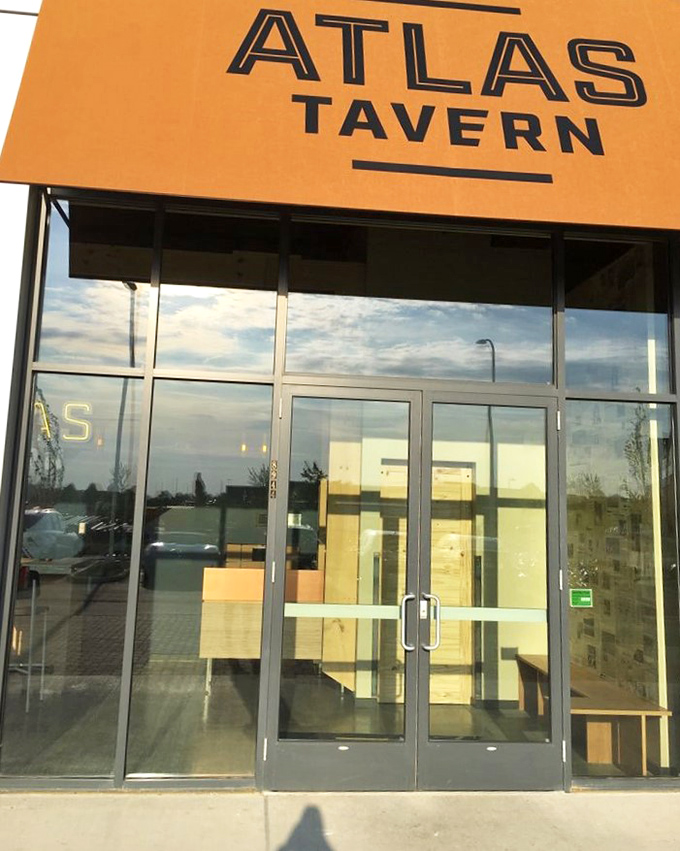 The entrance promises what the interior delivers&mdash;a contemporary take on tavern tradition with that signature Atlas yellow setting the tone. 