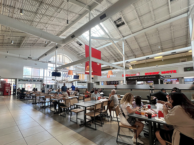 The food court buzzes with the universal language of hungry shoppers refueling for round two of retail therapy.