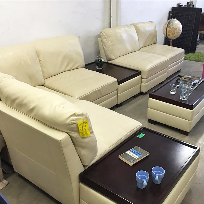 Living room goals on a ramen budget. This cream-colored sectional with matching tables could make apartment dwellers feel like they've upgraded to a penthouse.
