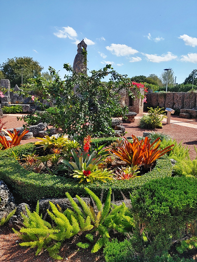 Tropical plants now soften the stark stone landscape, adding vibrant color to what must have been a much more austere setting during construction.