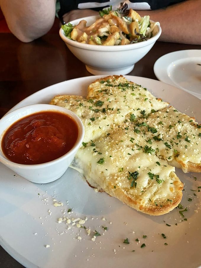 Garlic bread that achieves the impossible trifecta: crispy exterior, pillowy interior, and enough garlic to keep vampires at bay for a fortnight.