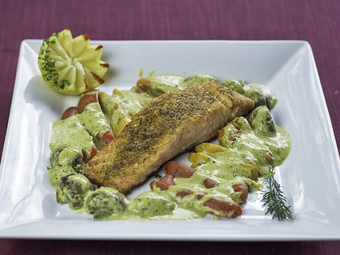 Perfectly grilled fish nestled in a vibrant sauce&mdash;proof that inland Wisconsin can rival coastal restaurants when it comes to seafood mastery.