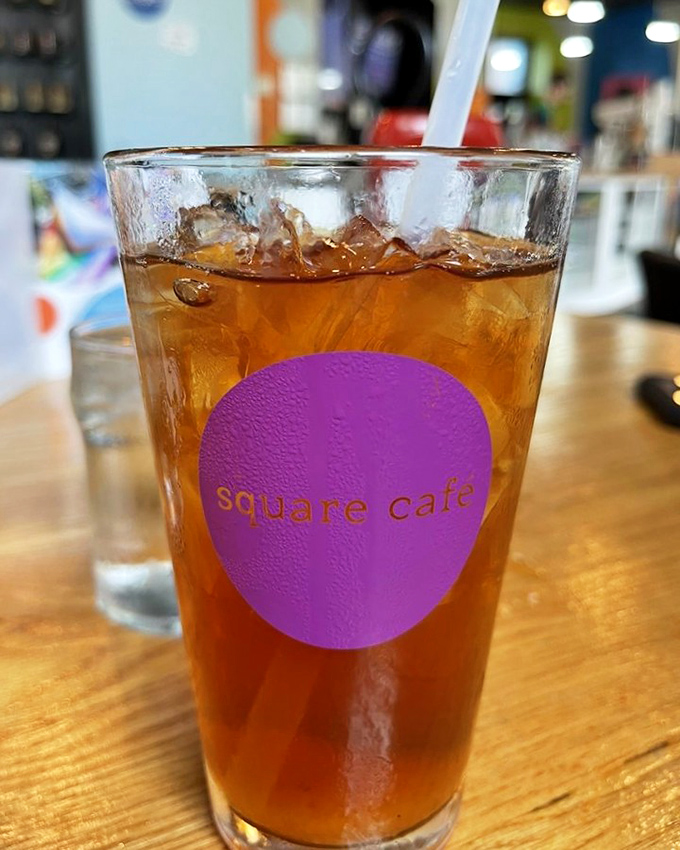 Iced tea in a glass that sweats with anticipation, the purple logo promising refreshment that Pittsburgh summers practically demand.