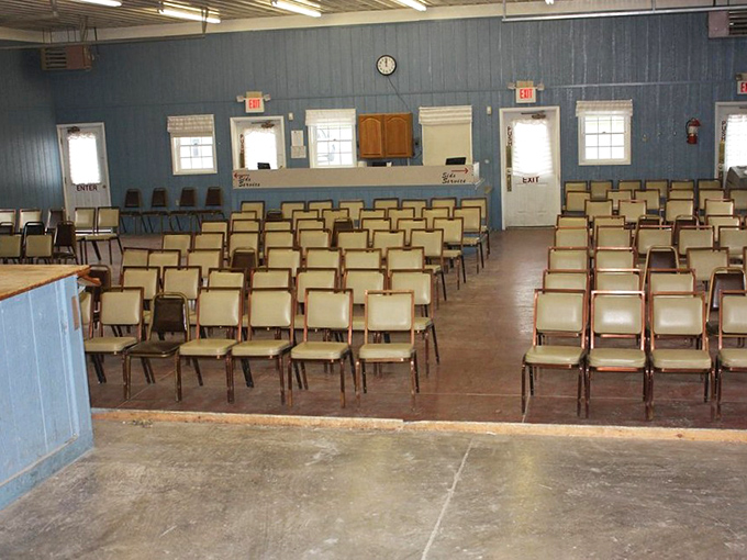 The auction barn sits quiet before the rapid-fire bidding begins. Those chairs have witnessed countless raised eyebrows and subtle nods that won treasures.