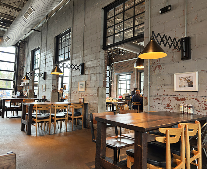 Industrial meets inviting. Those accordion lamps and distressed walls aren't just design choices&mdash;they're conversation starters between bites of brisket. 