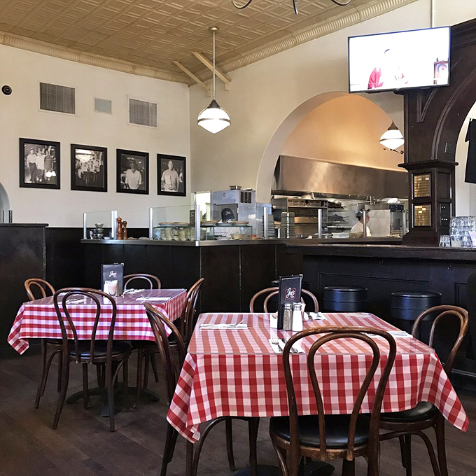 Red checkered tablecloths against dark wood chairs create that perfect diner aesthetic&mdash;like you've stepped into Edward Hopper's "Nighthawks," but with better lighting.