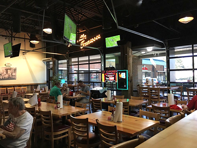 Sports on the screens, but the real spectator sport is watching first-timers tackle the XXX Hot. The "Tennessee" sign glows like a spicy welcome.