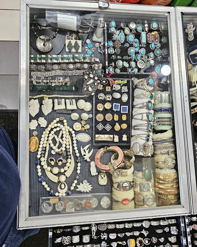 A jewelry case organized with the precision of a museum curator, where every gemstone and setting tells a different story.