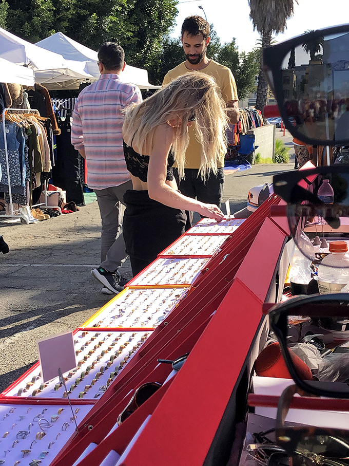 A treasure chest of rings sparkles under the open air, tempting browsers to try on a bit of history for their fingers.