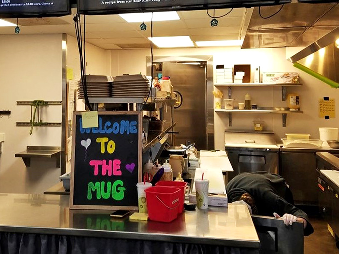 A colorful welcome sign brightens the kitchen pass. Even the back-of-house spaces radiate small-town charm.