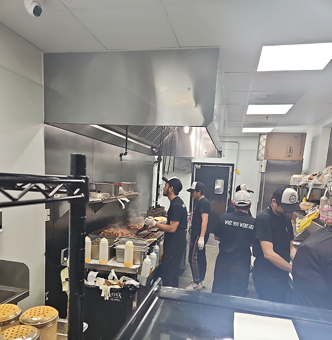 Behind the scenes where the magic happens. That flat-top grill has probably seen more action than a Hollywood stuntman.