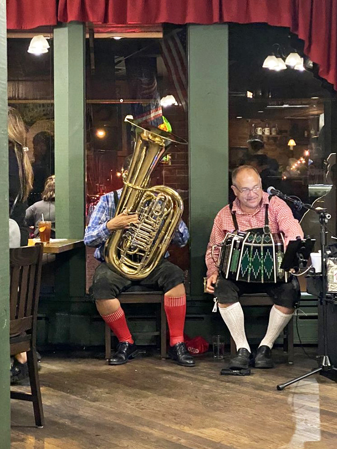 Musicians in traditional German attire bring authentic oompah vibes to dinner service&mdash;proving that live music makes everything taste better, especially sauerkraut.