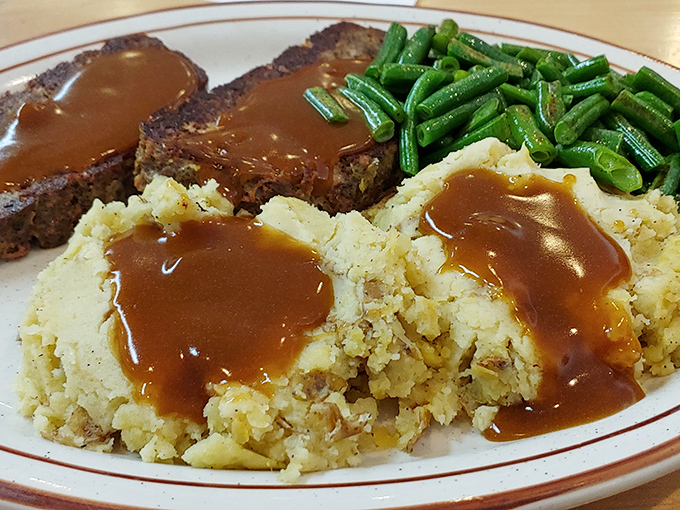 Meatloaf, mashed potatoes, and green beans&mdash;the holy trinity of diner cuisine. That gravy river flowing through the plate ties everything together like a good movie plot.
