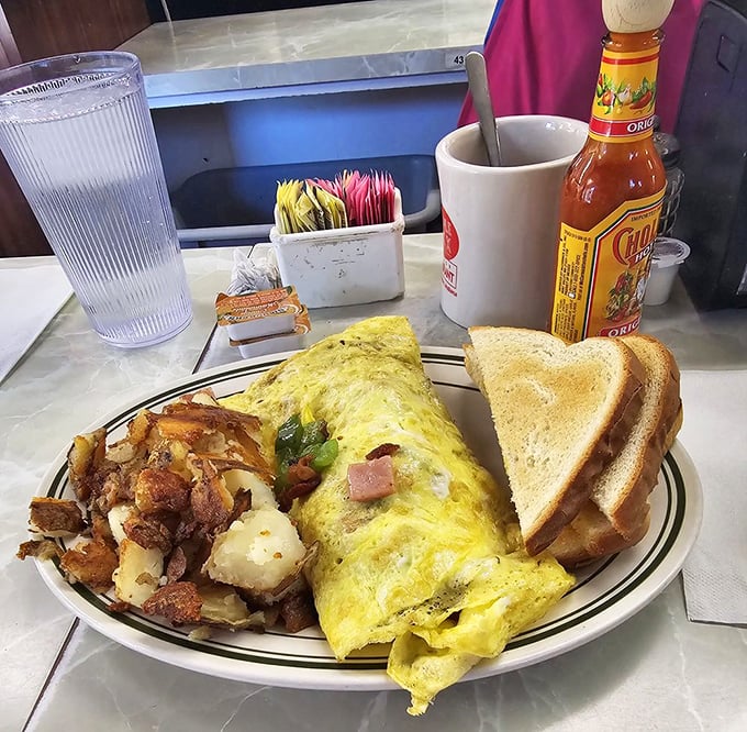 This omelet didn't just break free from its shell&mdash;it found its purpose in life alongside golden hash browns and toast.