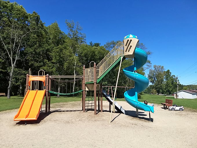 The playground stands ready for childhood memories to be manufactured, complete with slides that guarantee squeals of delight.