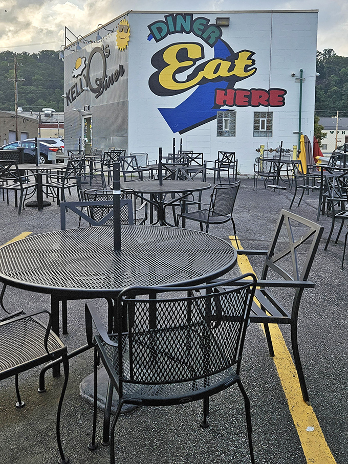 Outdoor seating with a side of diner charm &ndash; the "DINER EAT HERE" mural practically dares you to walk past without stopping.