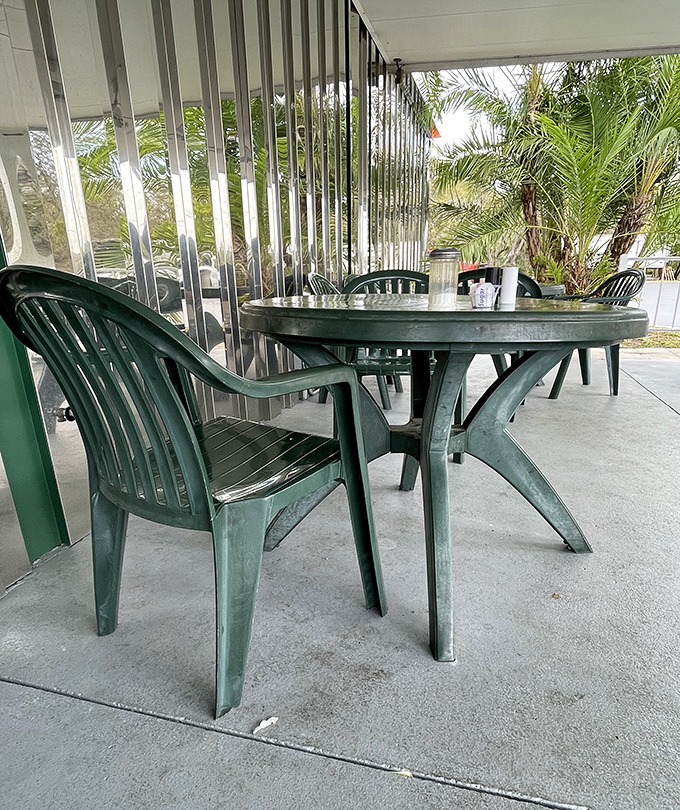 Outdoor seating with a side of Florida sunshine. The corrugated glass panels create a greenhouse effect perfect for both plants and people-watching. 
