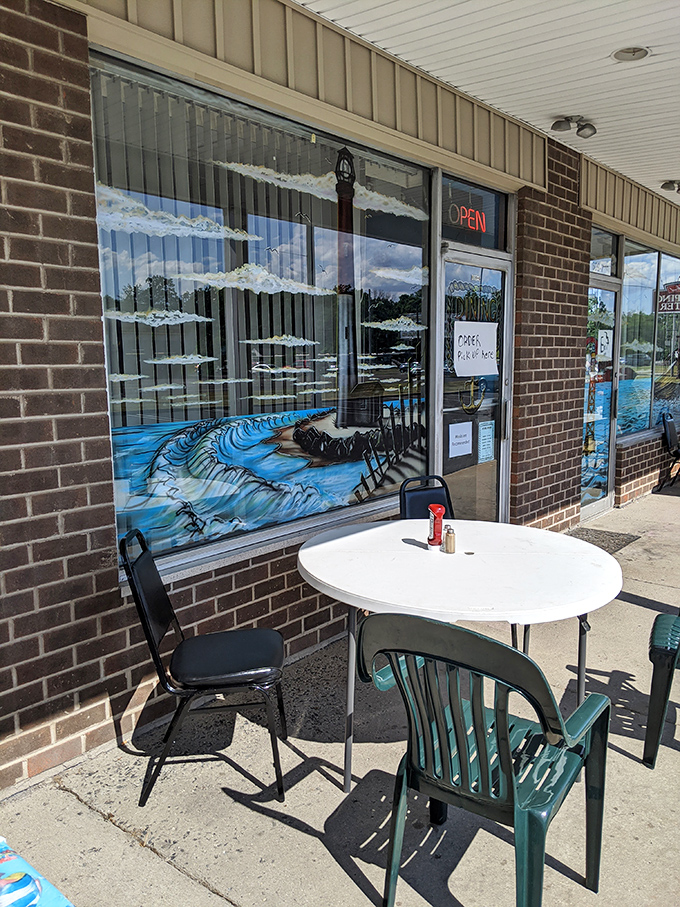 Sidewalk dining with a view of Captain Bob's ocean-inspired window art. Sometimes the best seafood comes with a side of fresh air and people-watching.