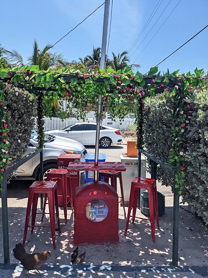 The outdoor seating area, where tropical flowers and red stools create the perfect setting for between-bite conversations.