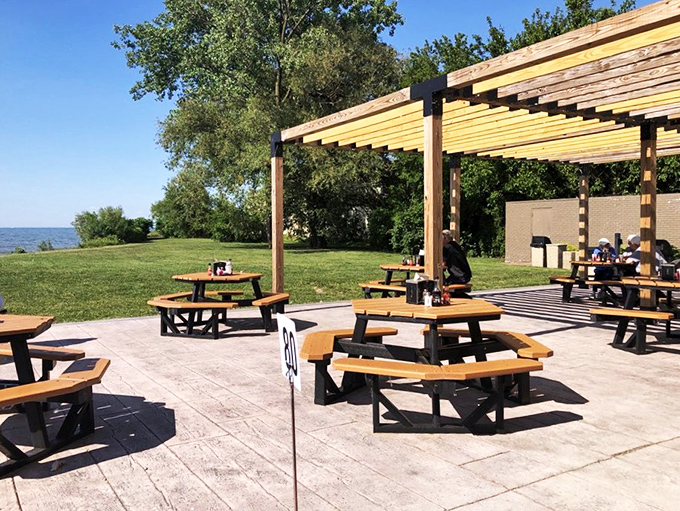 Lakeside dining that whispers "summer" even on cloudy days. These outdoor tables offer front-row seats to nature's greatest show: Lake Erie in all her glory.