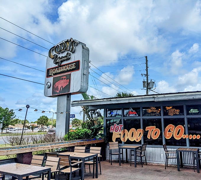 The outdoor seating area where Florida's perfect weather days meet hungry patrons. That vintage sign has witnessed countless first dates and anniversary celebrations.