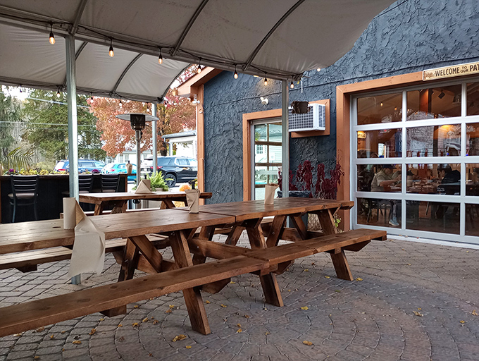 Outdoor picnic tables under string lights create the ideal setting for summer evenings with friends and sauce-stained fingers.