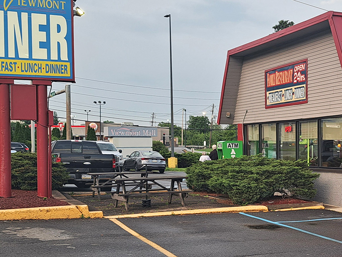Even the exterior offers a place to enjoy your meal, with picnic tables nestled between shrubs and the iconic red-roofed building.