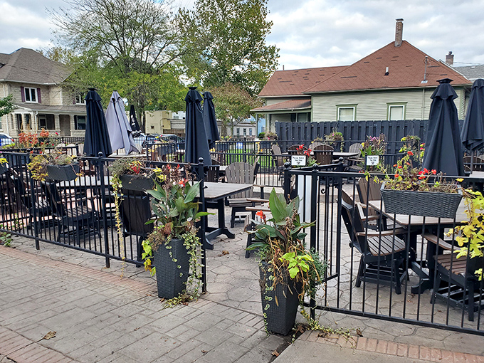 The outdoor patio offers a garden-like retreat where umbrellas stand ready to shield you from everything except food envy from neighboring tables.