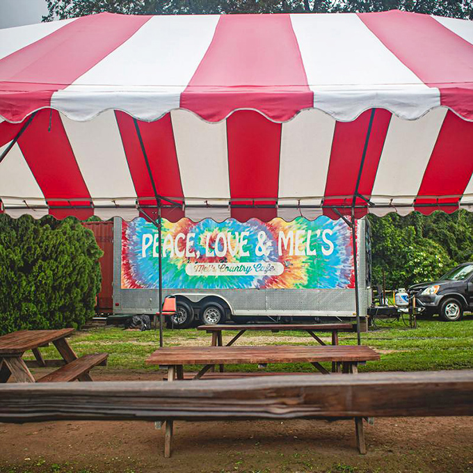 "Peace, Love & Mel's" says it all. This outdoor area isn't just a place to eat; it's where community happens, one picnic table at a time.