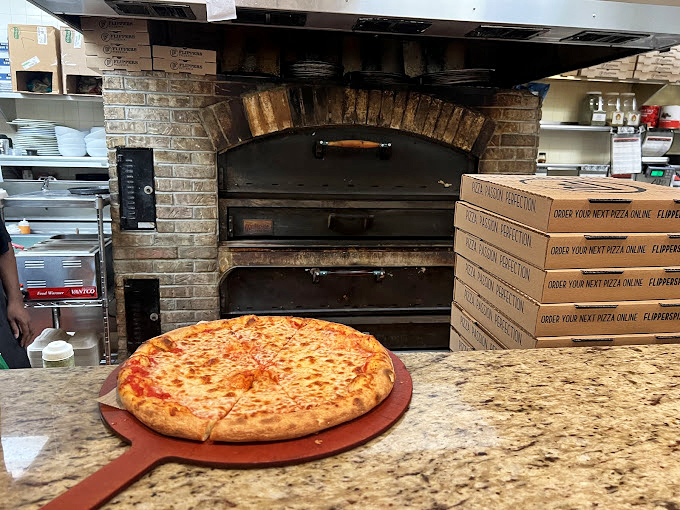The brick oven&mdash;where dough goes in and dreams come out. That perfect char comes from fire, not a corporate handbook.